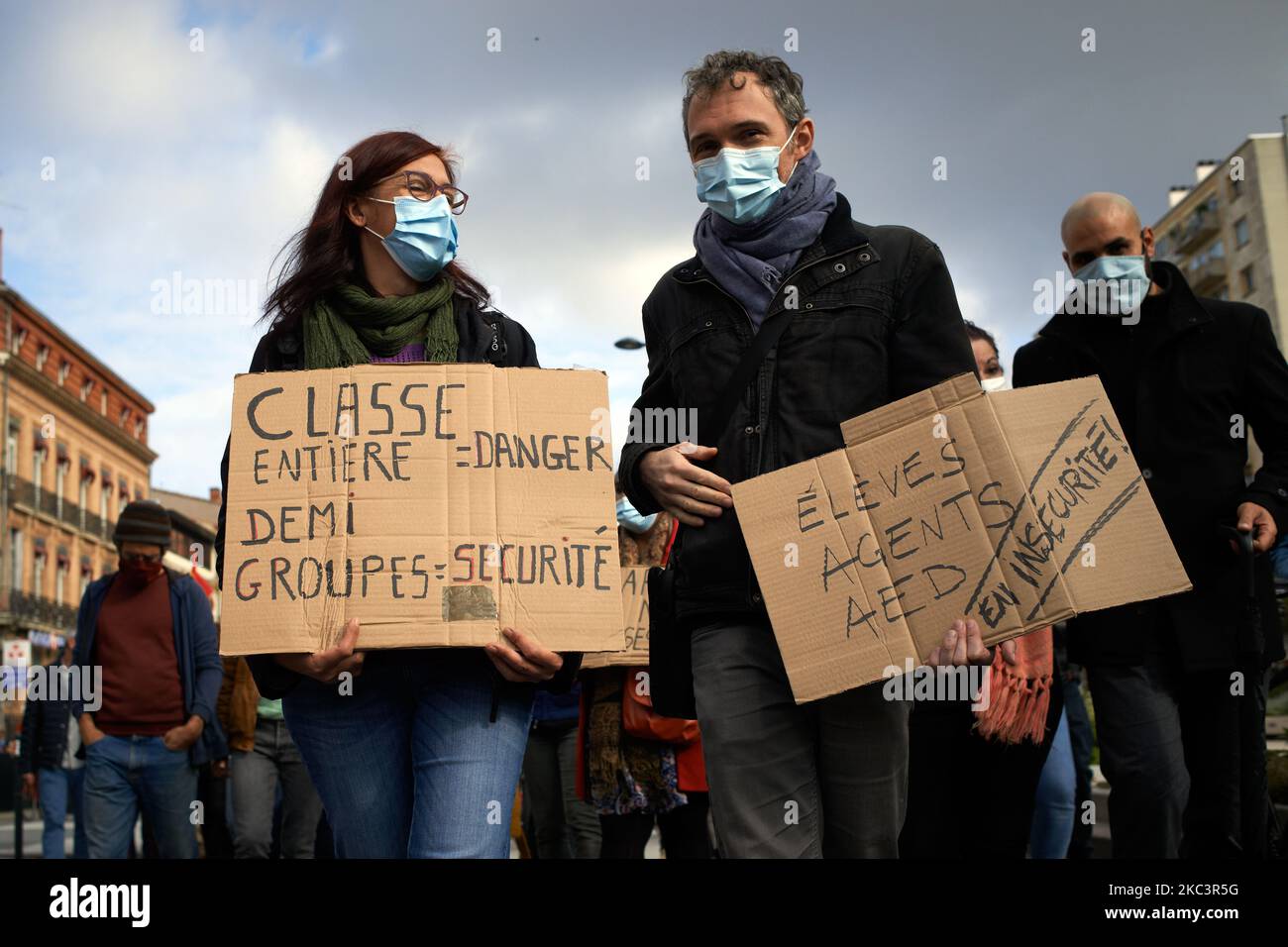 Two protesters hold two placards reading (from left to right): 'Full ...