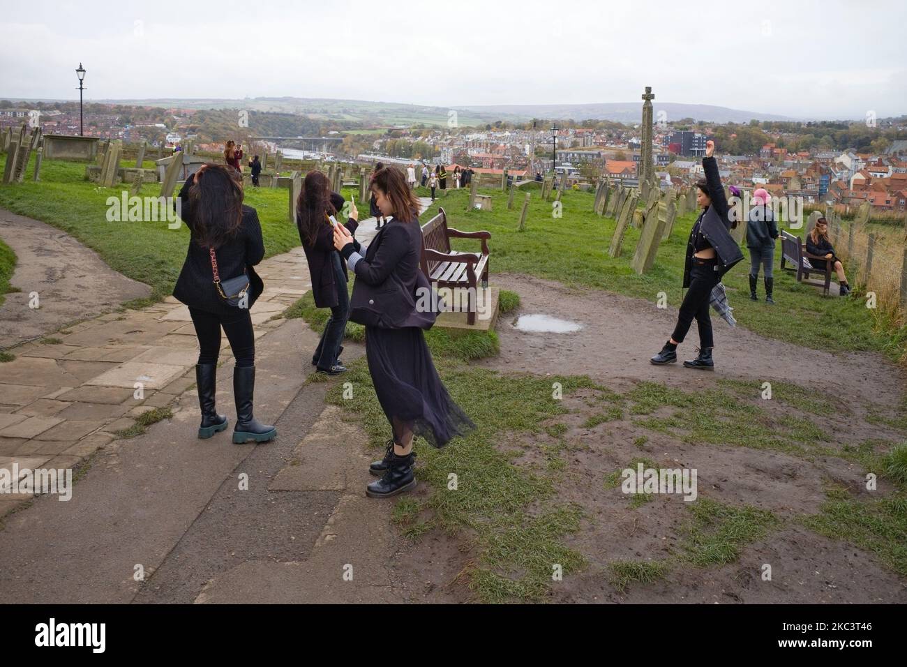 A group of Chinese girl students taking photos of each other high above ...