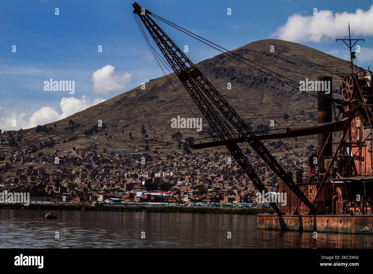 An old rusty crane in Lake Titicaca with the mountain in the background ...