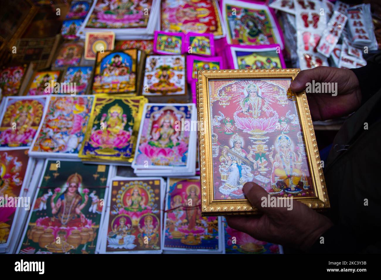 A man sells picture of Goddess Laxmi for the upcoming Tihar festival at ...