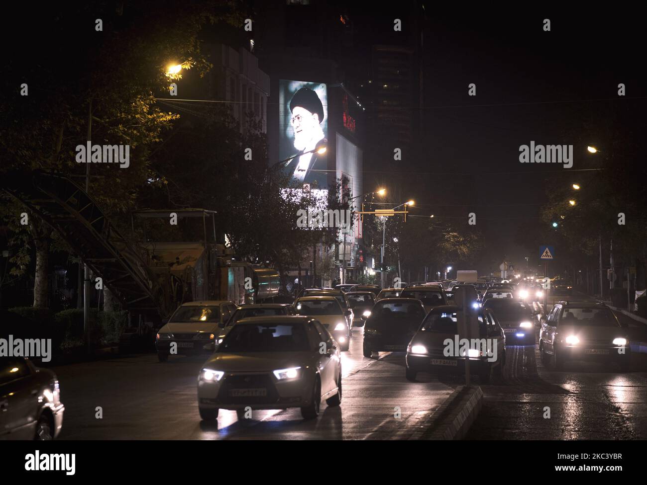 Vehicles drive past a portrait of Iran’s Supreme Leader Ayatollah Ali ...