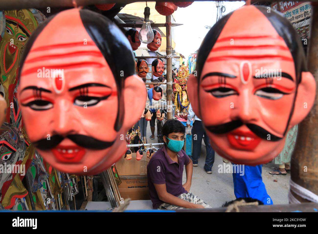 A vendor warring protective facemask waiting for customer clay-made ...