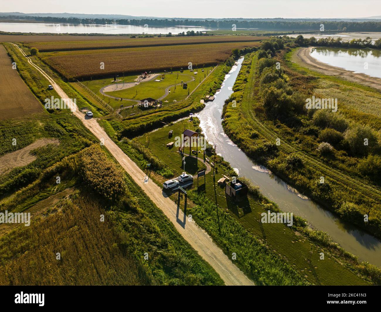 An aerial view of a field with small ponds next to the road Stock Photo ...