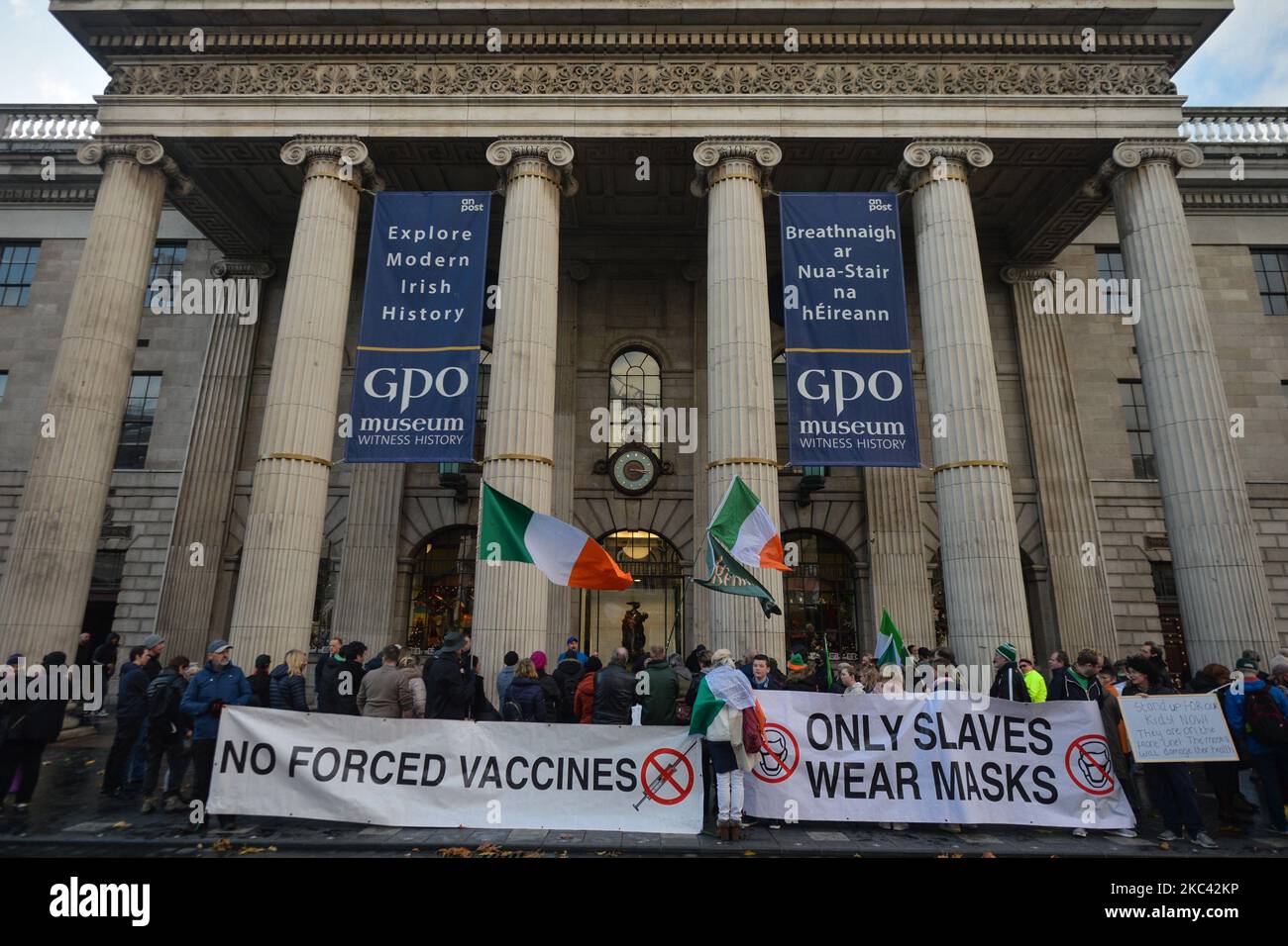 A group of demonstrators carrying banners and tricolour flags seen ...