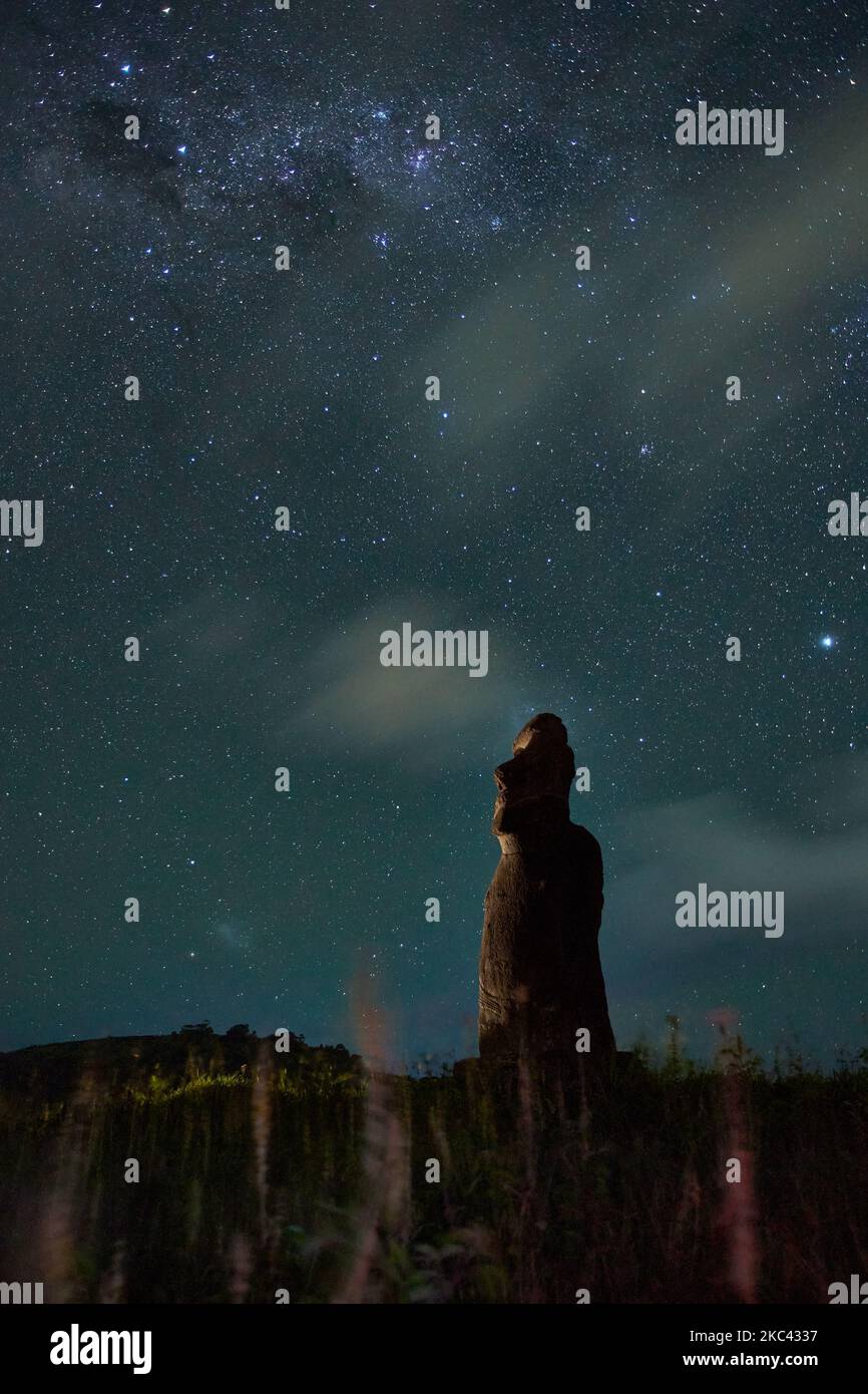 The Moai stone monolithic statue at night with starry sky in the ...