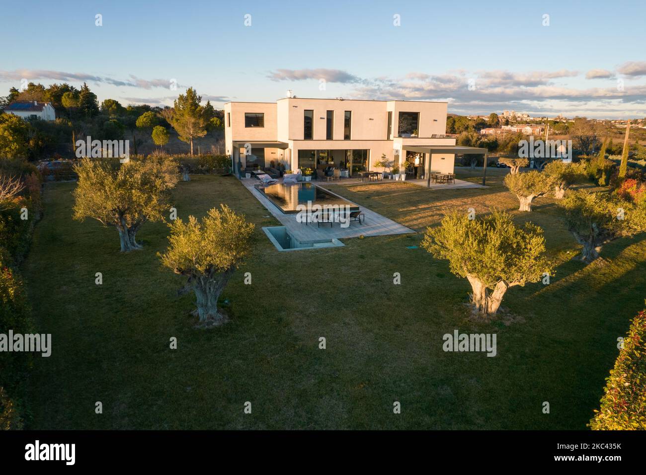 An aerial view of a large white contemporary house in geometric shapes ...
