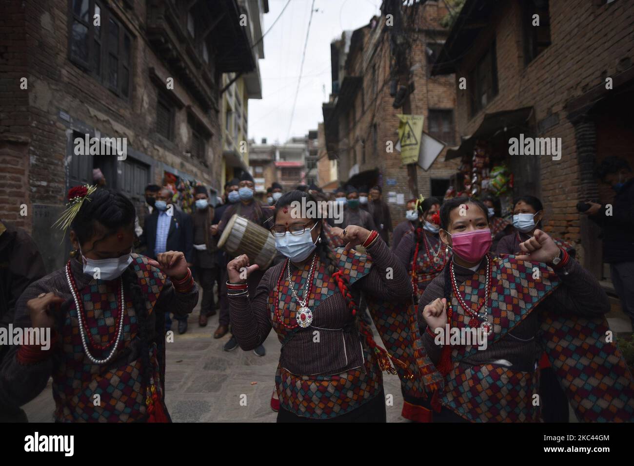 Newari people dance in a traditional tunes along with the face mask ...