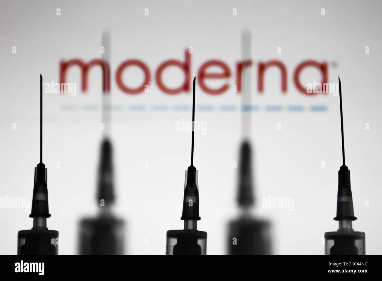 Medical syringes are seen with Moderna company logo displayed on a ...