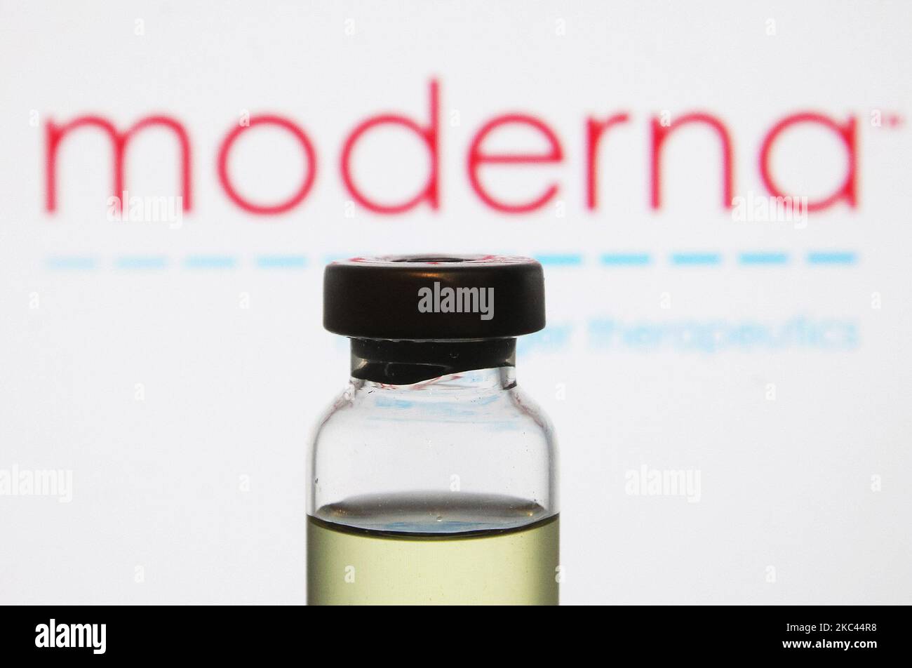 A vial in front of the Moderna logo is seen in this creative photo. The ...