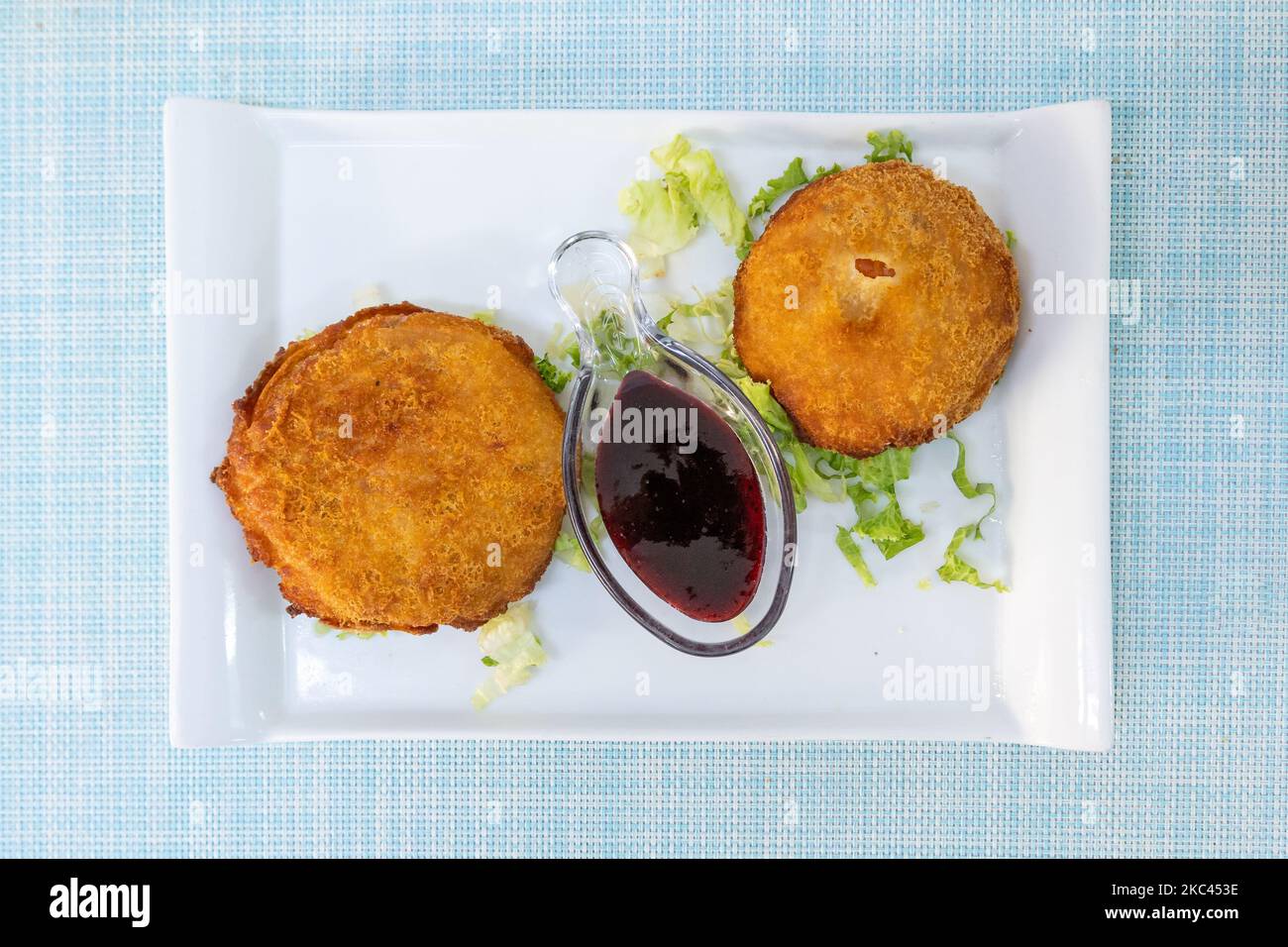 A top view of fish cakes with sauce on a white rectangular plate Stock ...