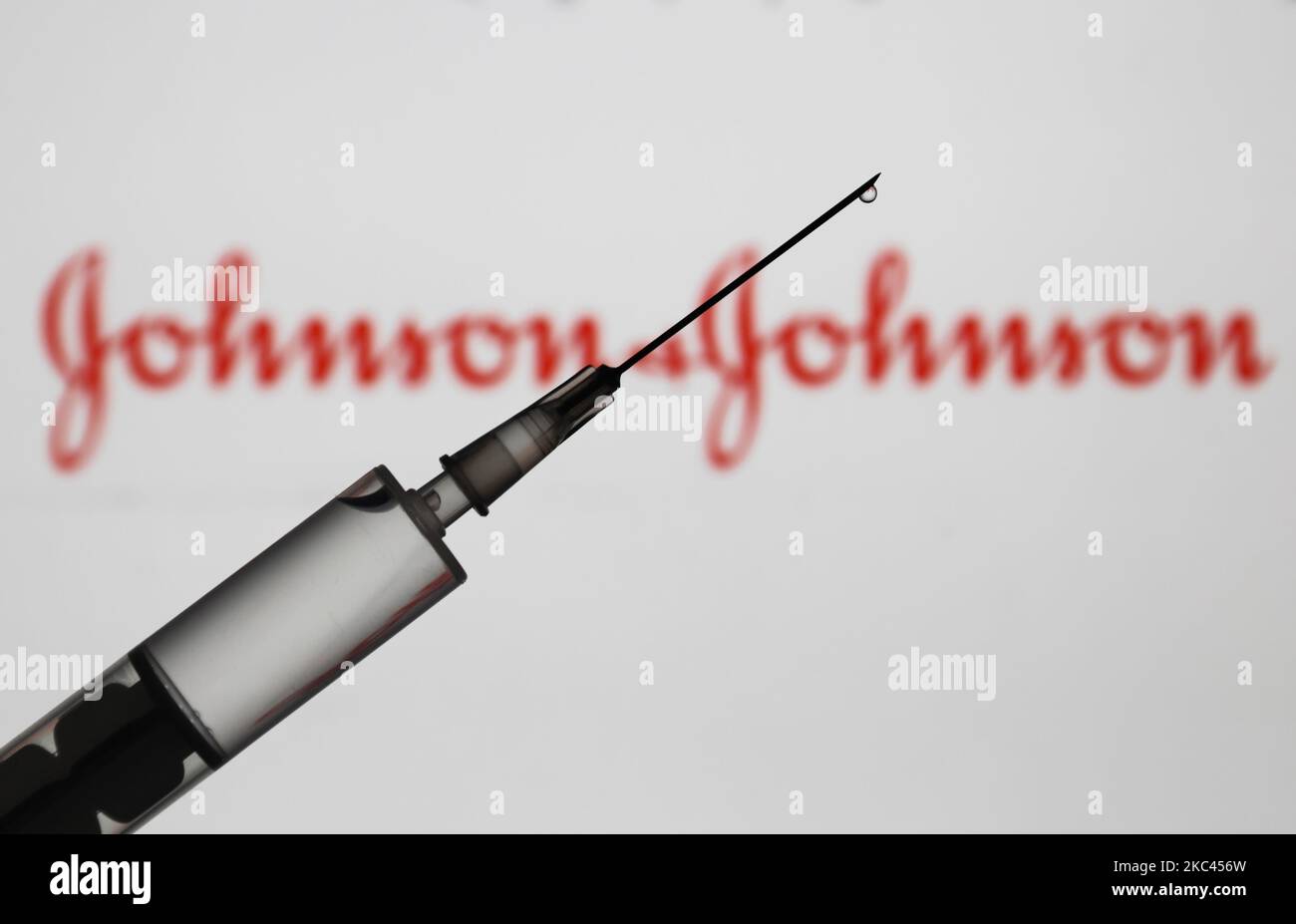 Medical syringe is seen with Johnson and Johnson company logo displayed ...
