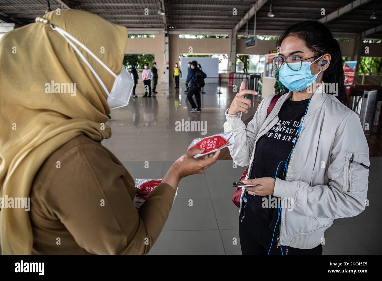 Public Health Officers gives protective masks and announces health ...