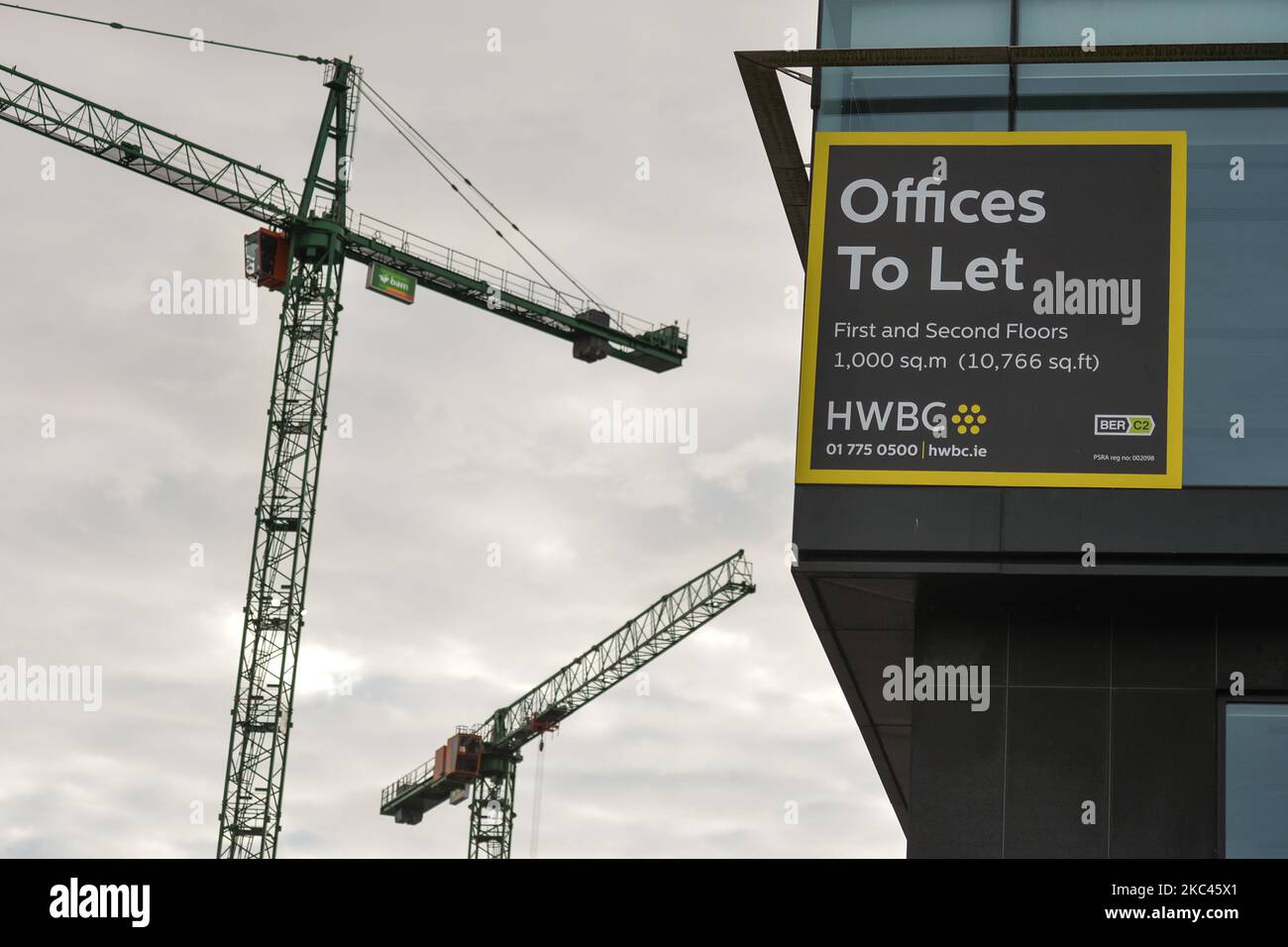 A sign 'Offices To Let' near to an ongoing construction site in Grand ...