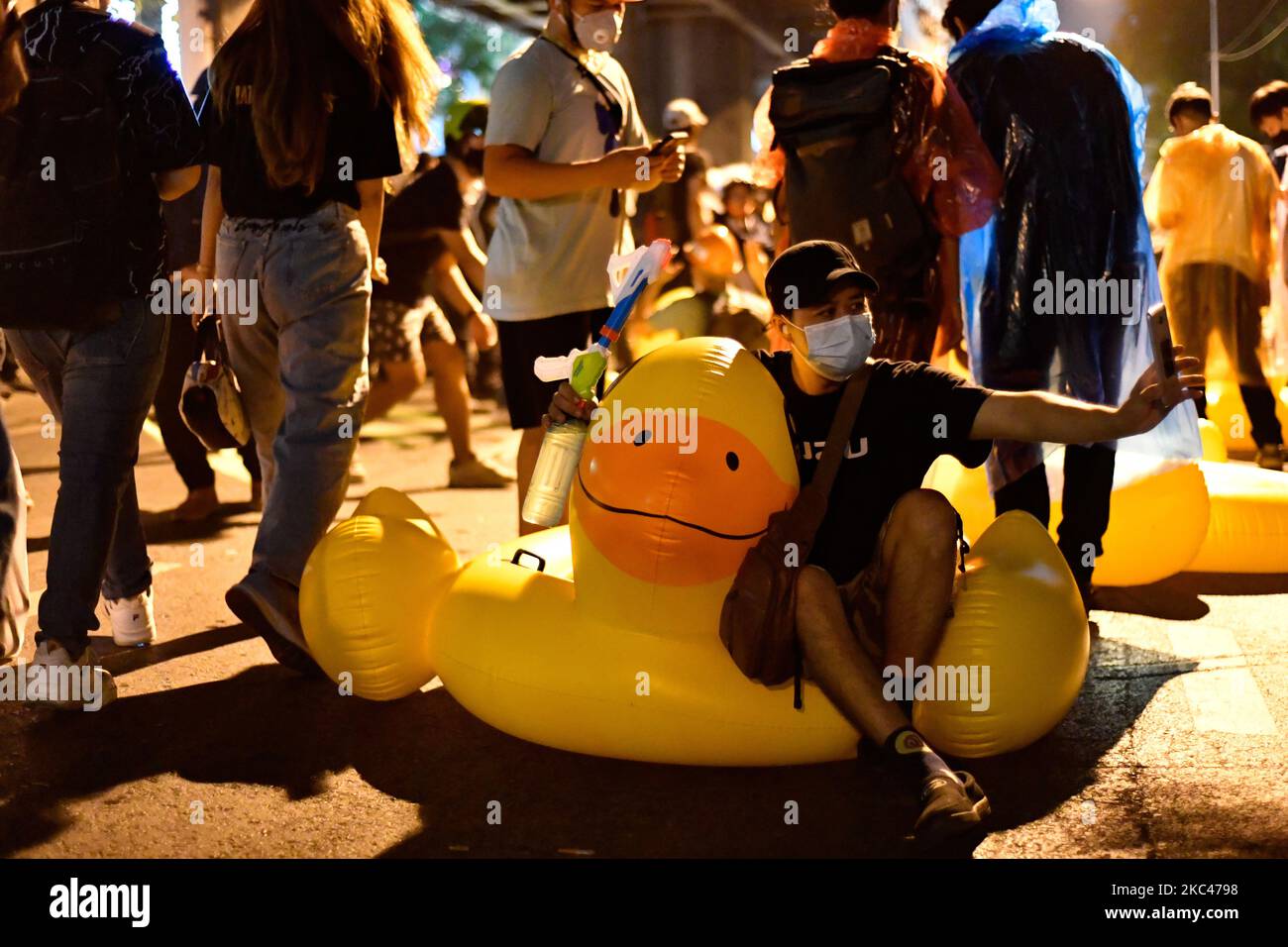 A pro-democracy protester takes a selfie with an inflatable rubber duck ...