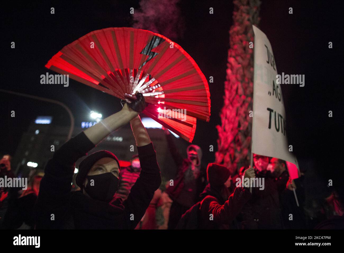 Woman holds hand fun with Womans Strike symbol during blockade of ...