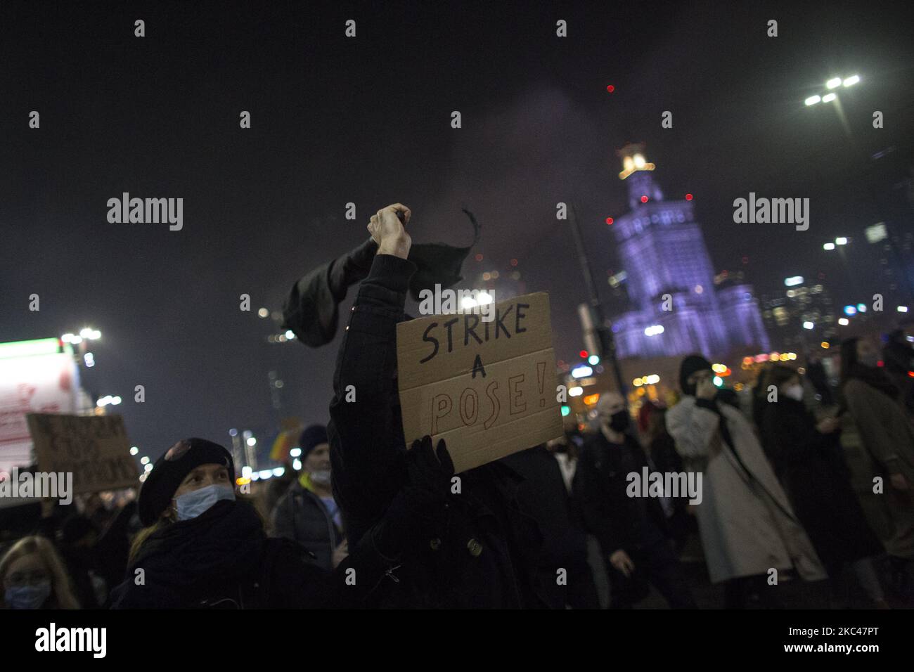 Man holds Strike A Pose banner during blockade of parliament by ...