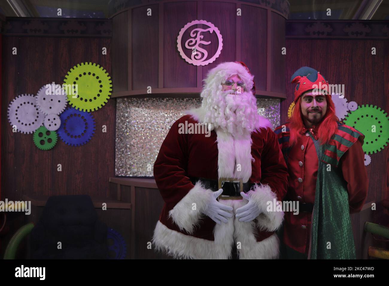 A person characterized as Santa Claus, an elf, organizers and sponsors ...