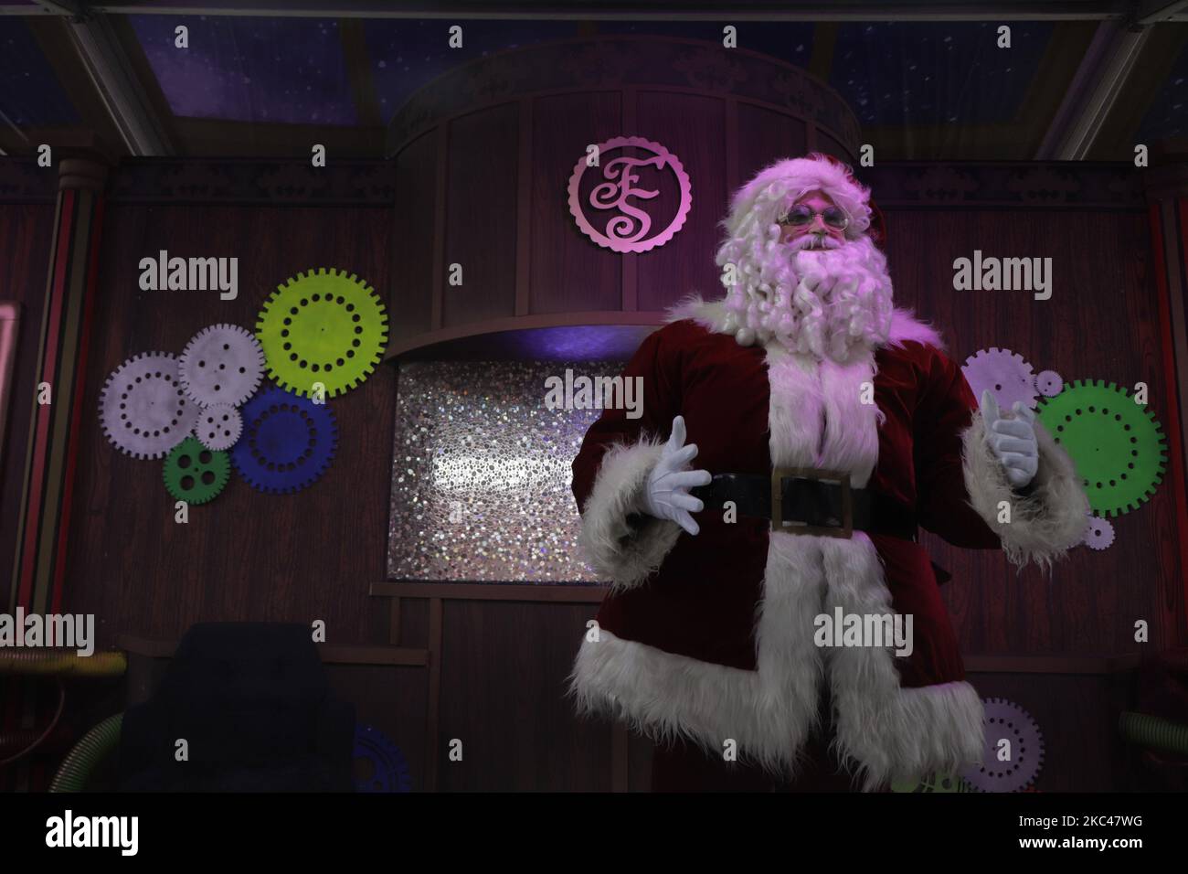 A person characterized as Santa Claus in a section of Santa's factory ...