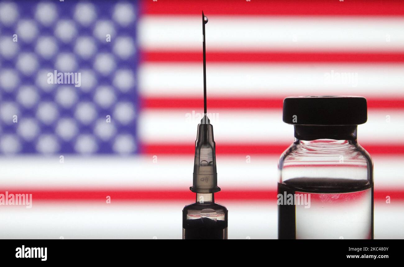 A medical syringe and a vial in front of the U.S. flag are seen in this ...