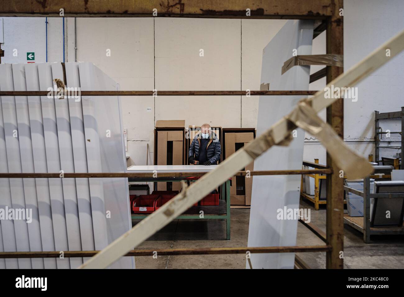 A worker of the Italian company Desmon assembling a part of a ...