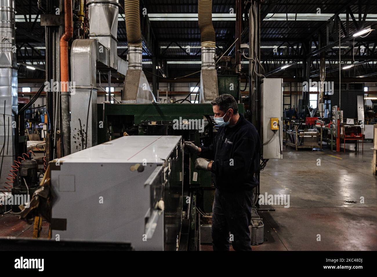 A worker of the Italian company Desmon assembling a part of a ...