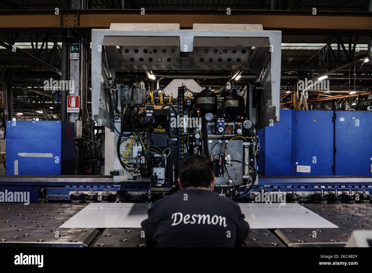A worker of the Italian company Desmon assembling a part of a ...