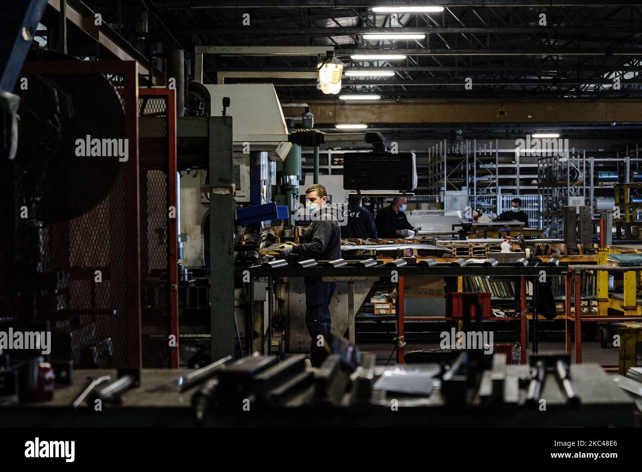 A worker of the Italian company Desmon assembling a part of a ...