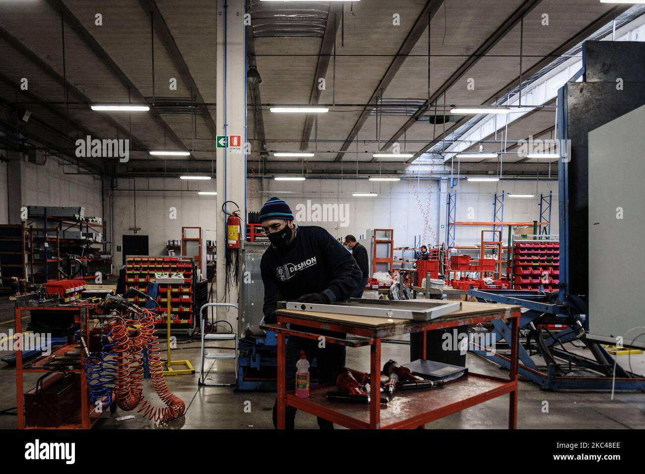 A worker of the Italian company Desmon assembling a part of a ...