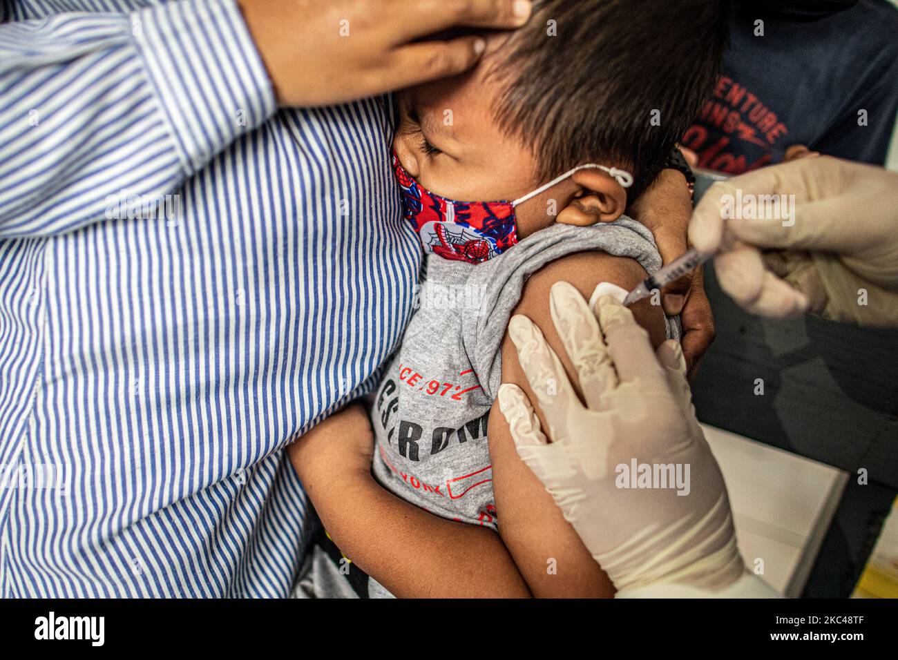 A child crying in his mother arms while received injection. Public ...