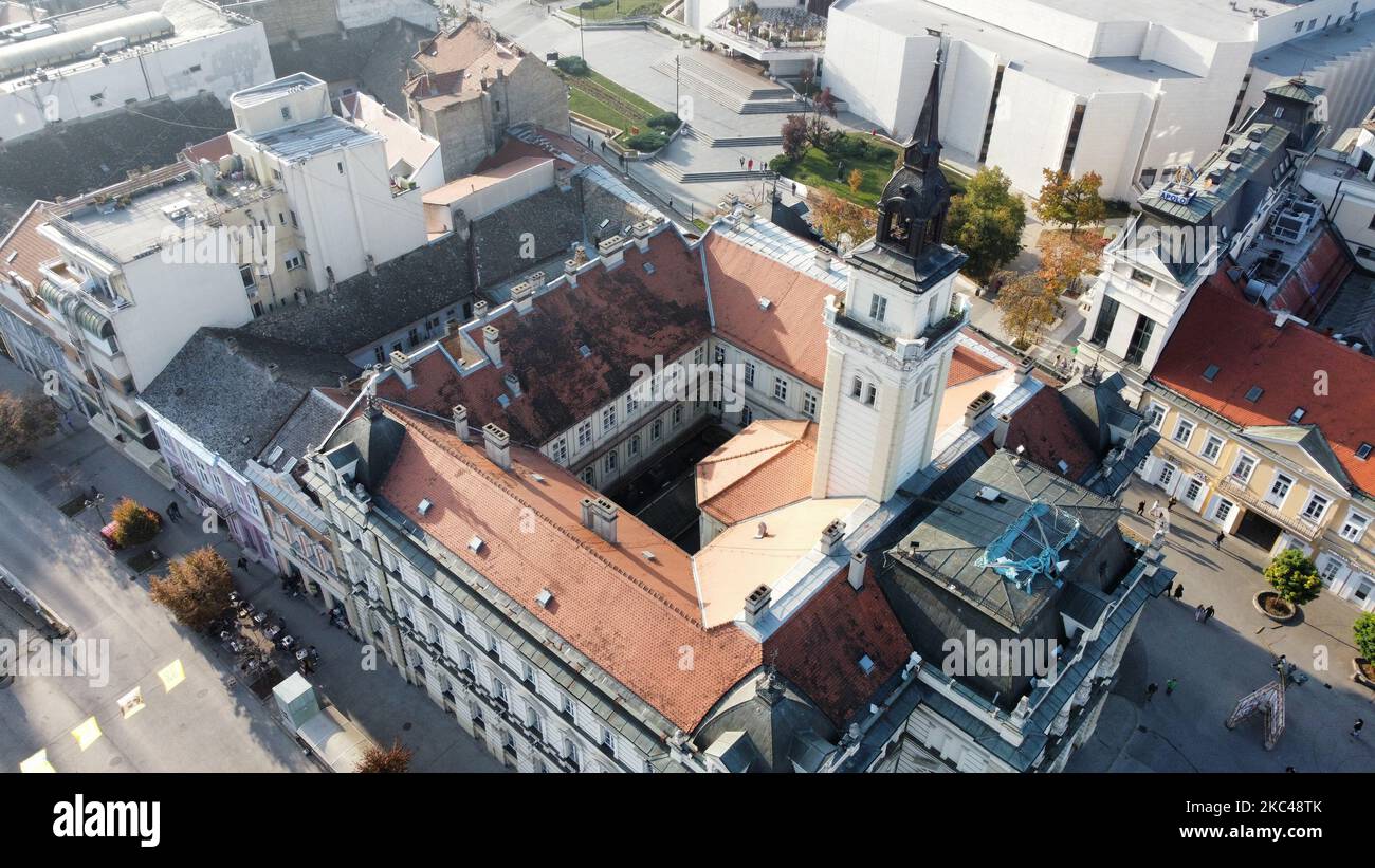 An aerial view of an old architectural building with a tower in a city ...