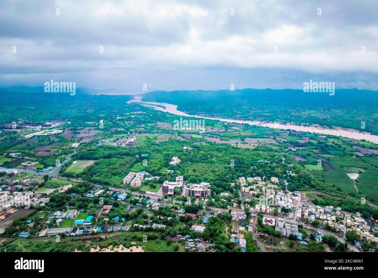 An aerial view of cityscape Rajpipla surrounded by buildings and ...