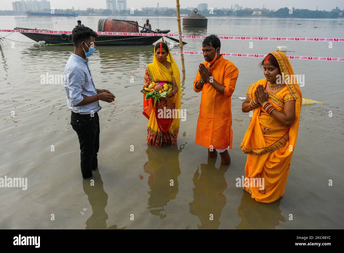 Devotees offering prayer to Sun god on the eve of chhath puja at a ...