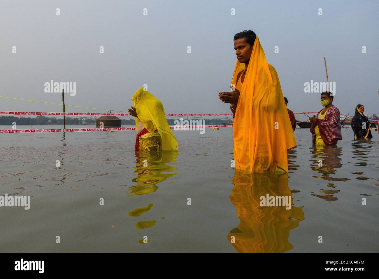 Devotees offering prayer to Sun god on the eve of chhath puja at a ...
