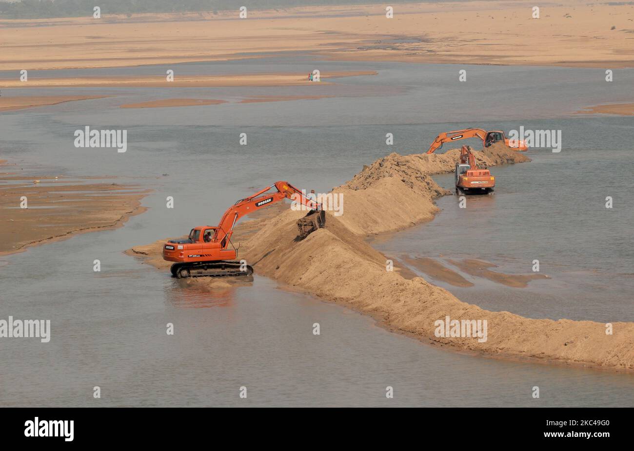 Laborers and other machines are seen inside the Kuakhai river as all ...