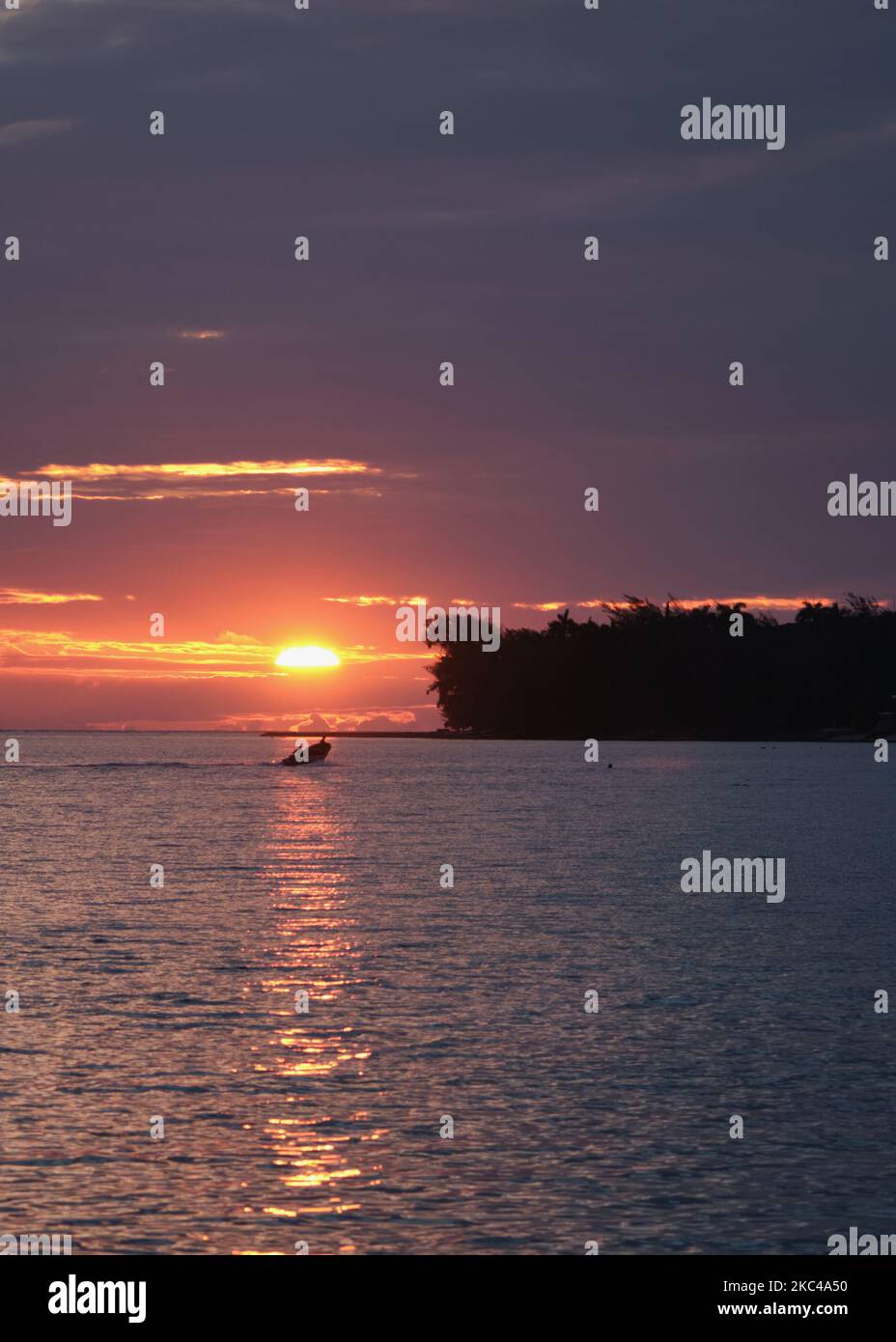 A dramatic scenery of a vibrant sunset in the sky over the horizon in ...