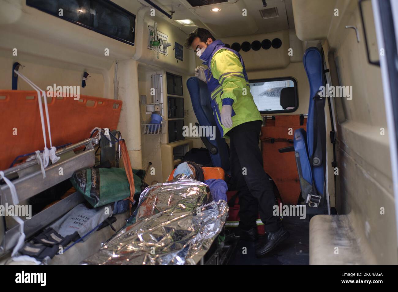A member of Iran’s Emergency Medical Services (EMS) stands as a man who ...