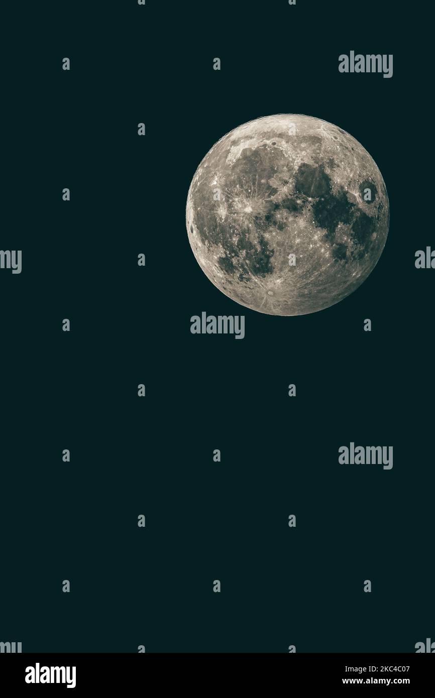 The gray full moon isolated on the black background, vertical Stock ...