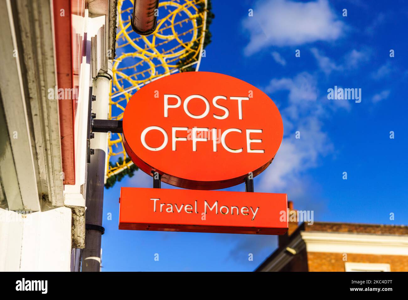Post Office sign set in front of a blue sky background Stock Photo - Alamy