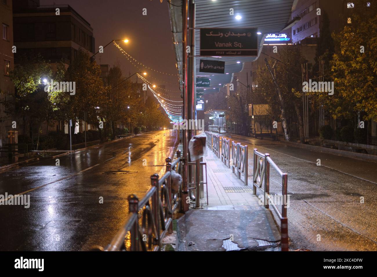 A view of a bus-stand and an avenue in northern Tehran at night which ...