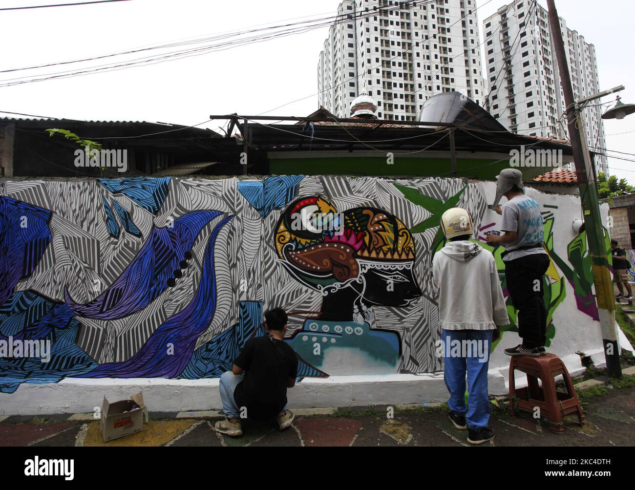 Indonesian local artists drew murals on the walls of the houses for the ...