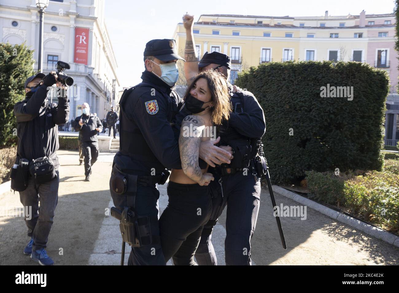 A FEMEN activist as she is retained by police when she was protesting ...