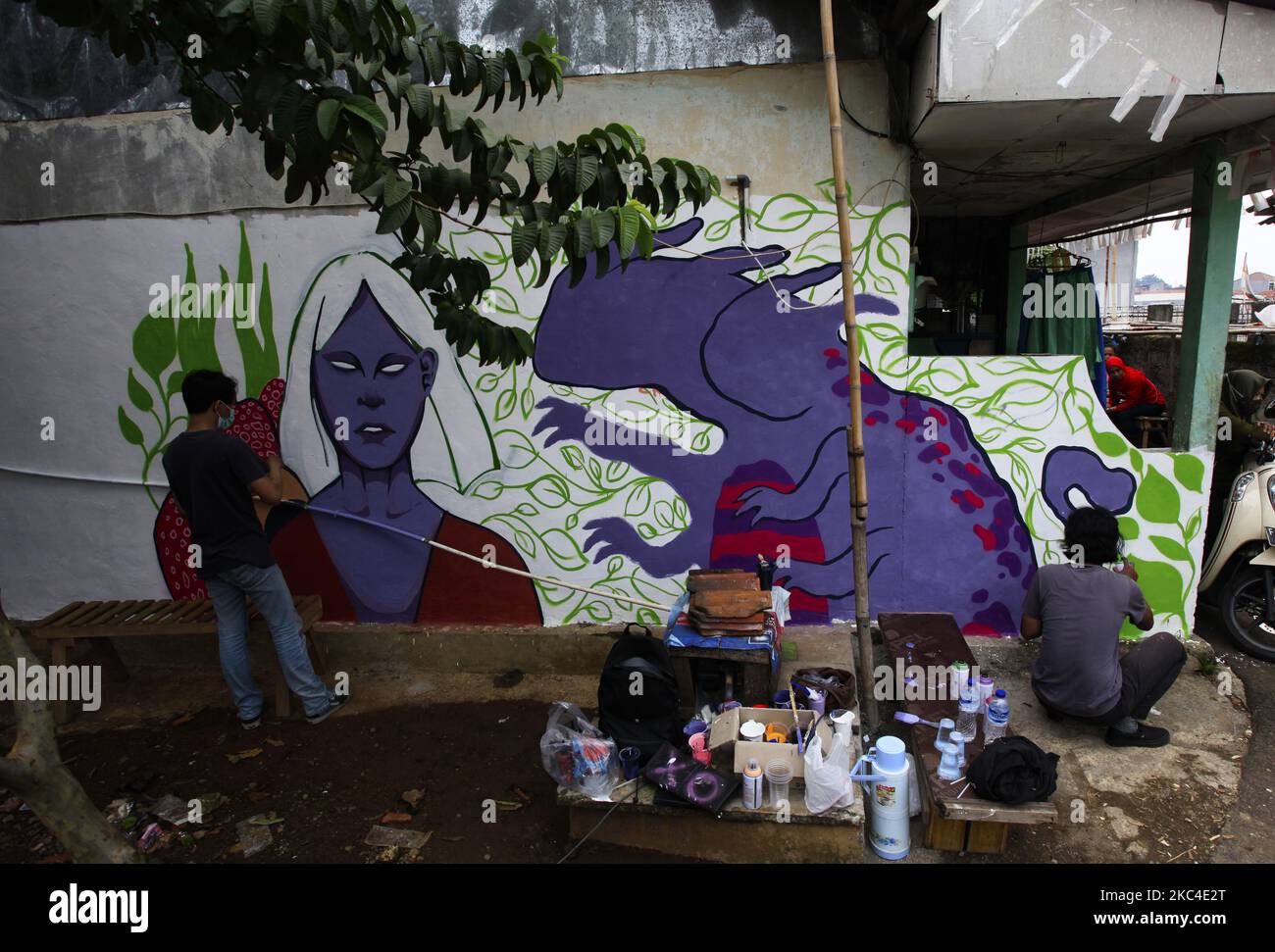 Indonesian local artists drew murals on the walls of the houses for the ...