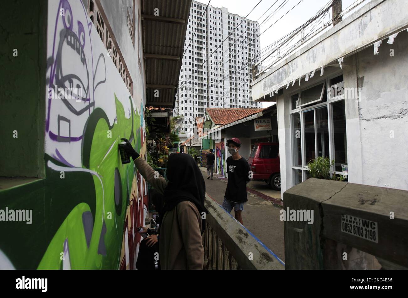 An Indonesian local artists drew graffiti on the walls of the houses ...