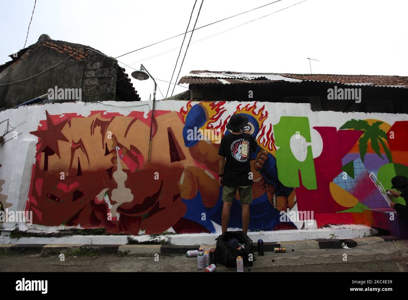 An Indonesian local artists drew graffiti on the walls of the houses ...