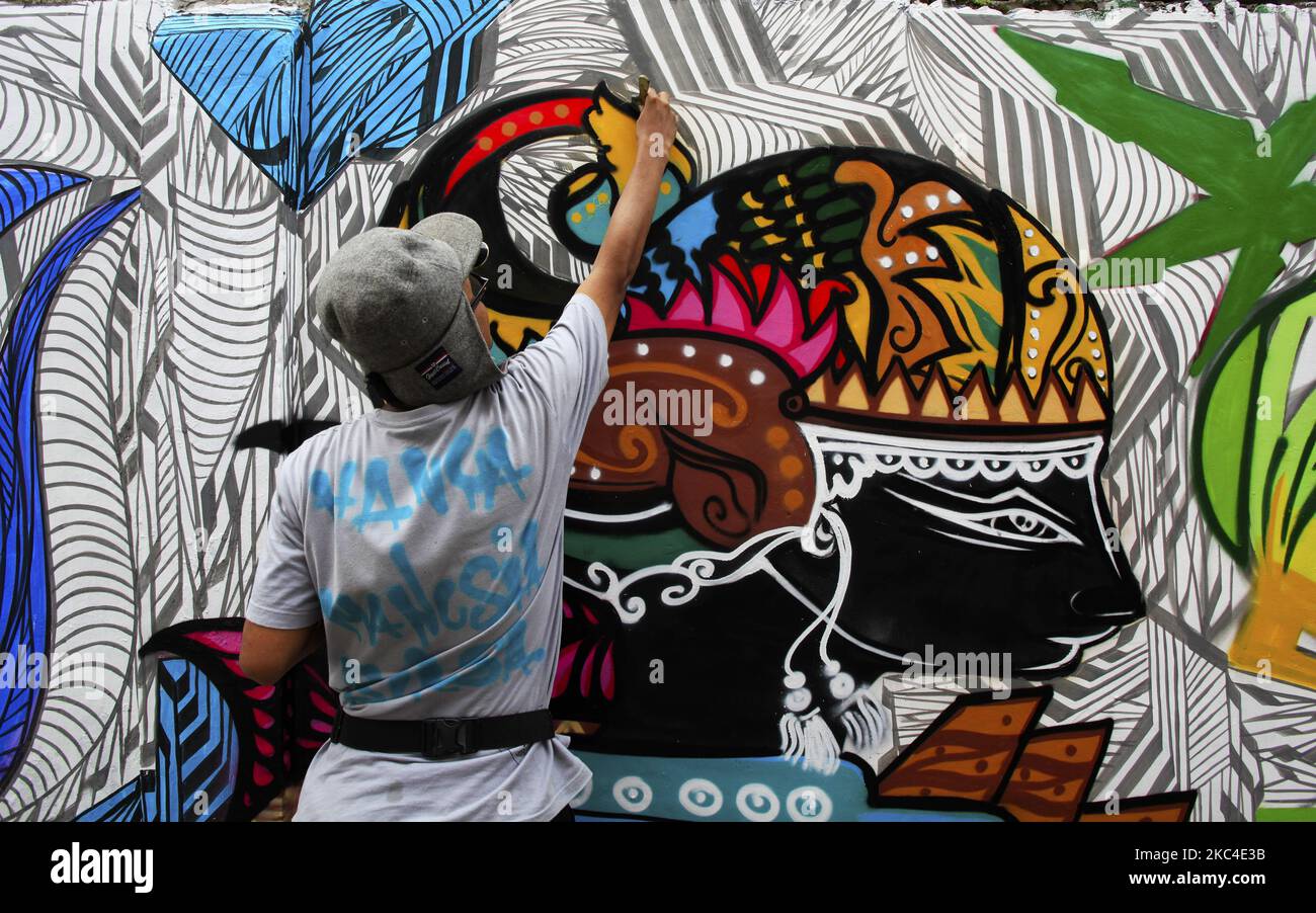 An Indonesian local artists drew graffiti on the walls of the houses ...