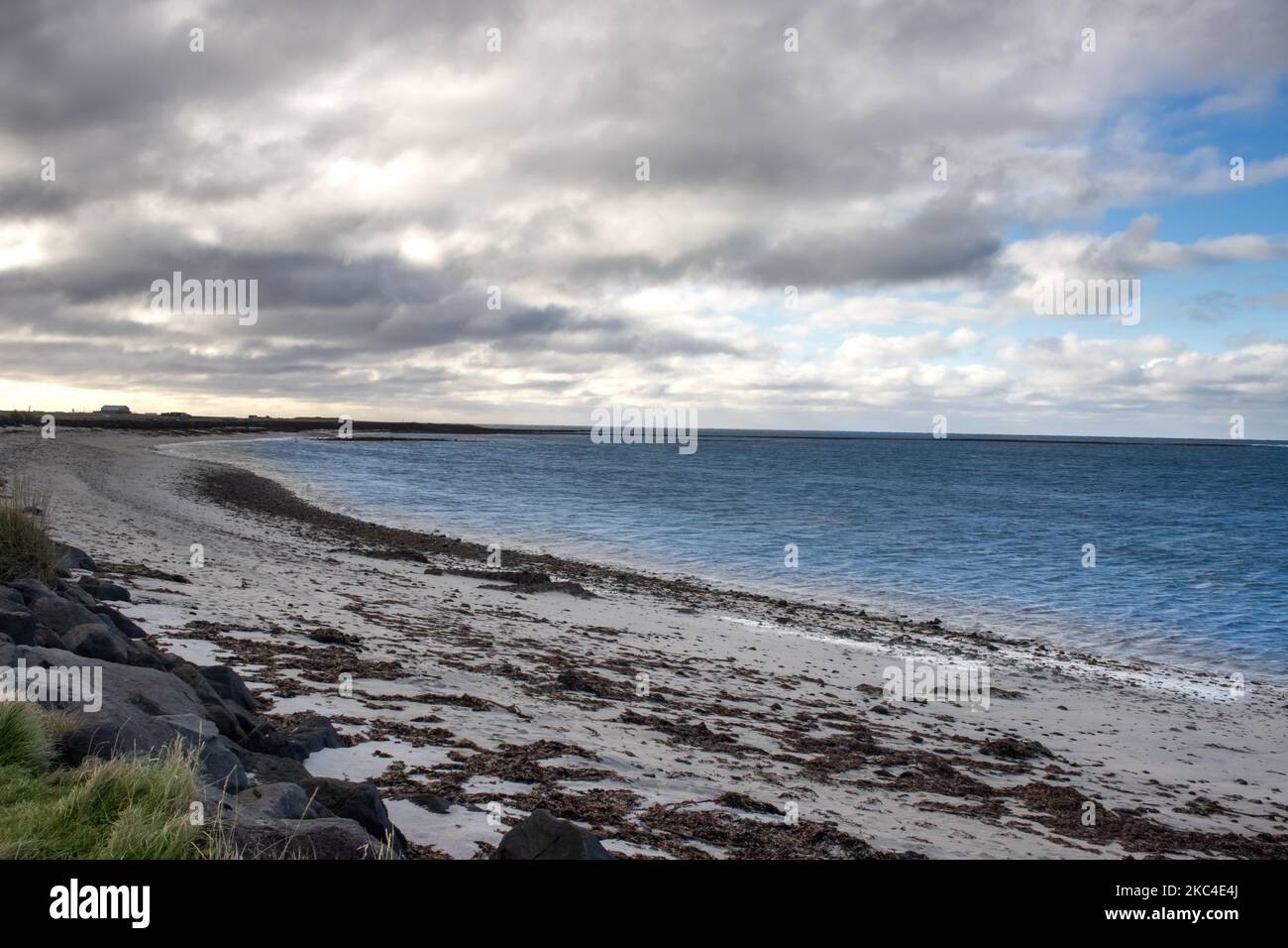 Islandic sea as a part of Atlantic ocean. Calm beach and dark blue sea ...