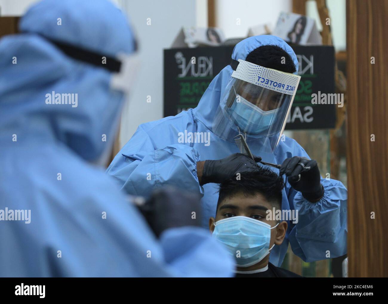 Sri Lankan hair dresser Sanjeewa Ranathunga wearing personal protective ...