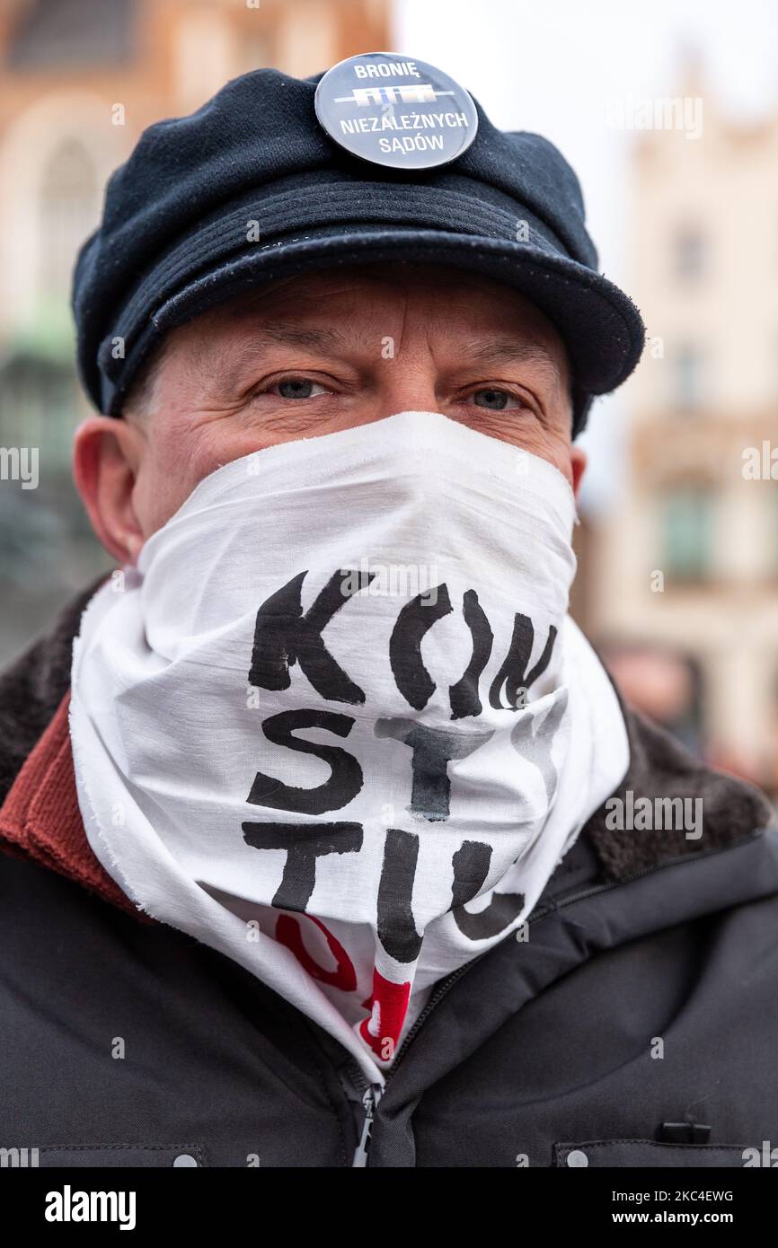 A man in a protective face mask is seen demonstrating his support for a ...