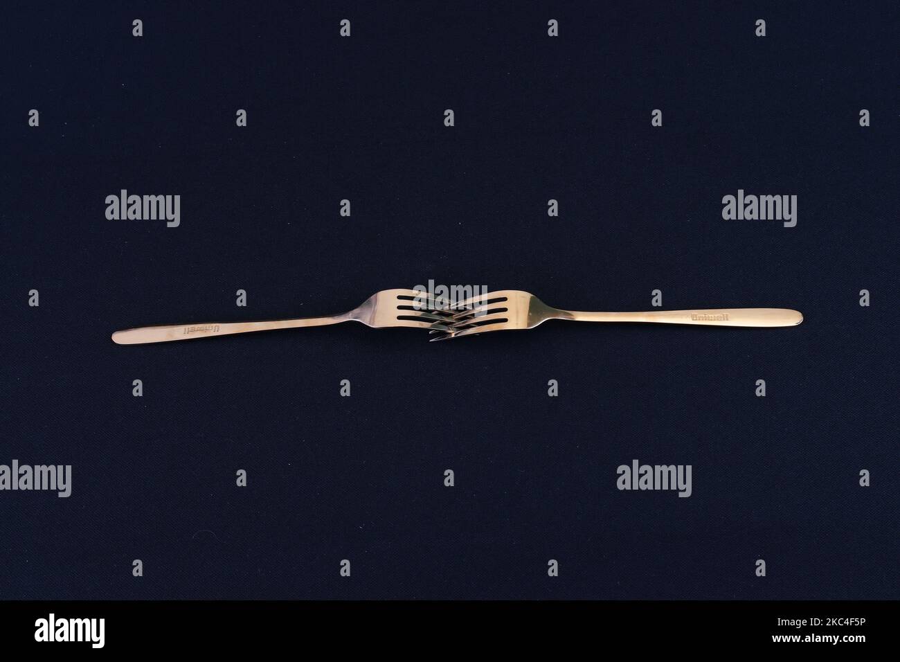 A top view of some forks placed on a dark blue background Stock Photo ...