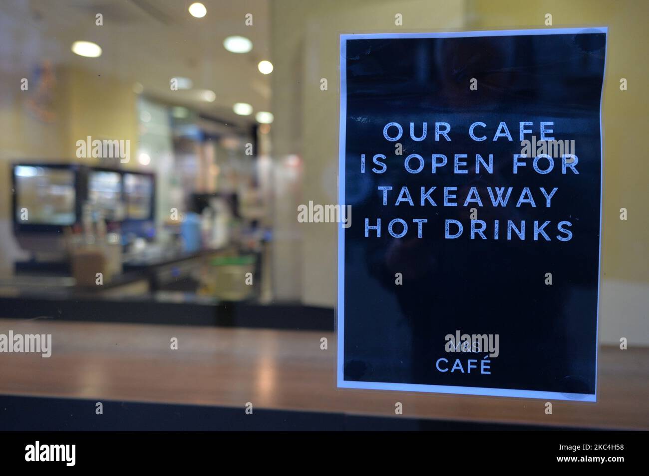 A sign 'Our Cafe Is Open For Takeaway Hot Drinks' seen in a shop window ...